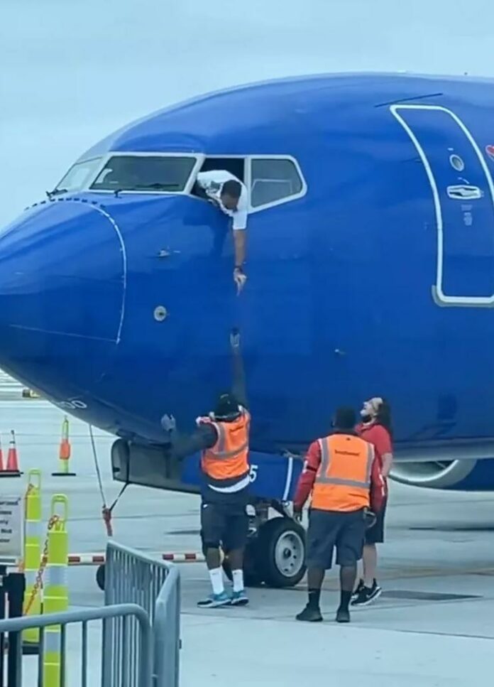 Pilot Hangs Out of Cockpit Window to Retrieve Passenger's Phone | WATCH ...